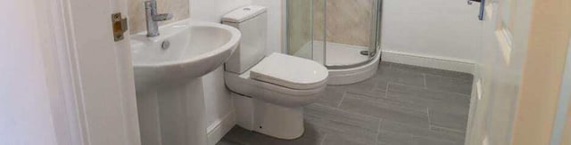 Why is my toilet backing up into my shower and how do I stop it?